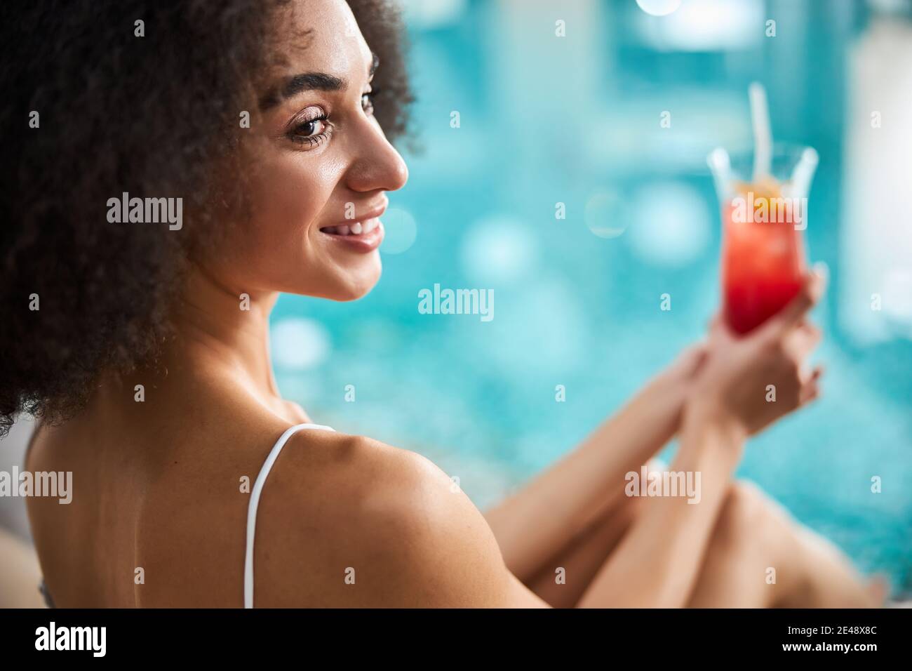 Woman lounging poolside hi-res stock photography and images - Alamy