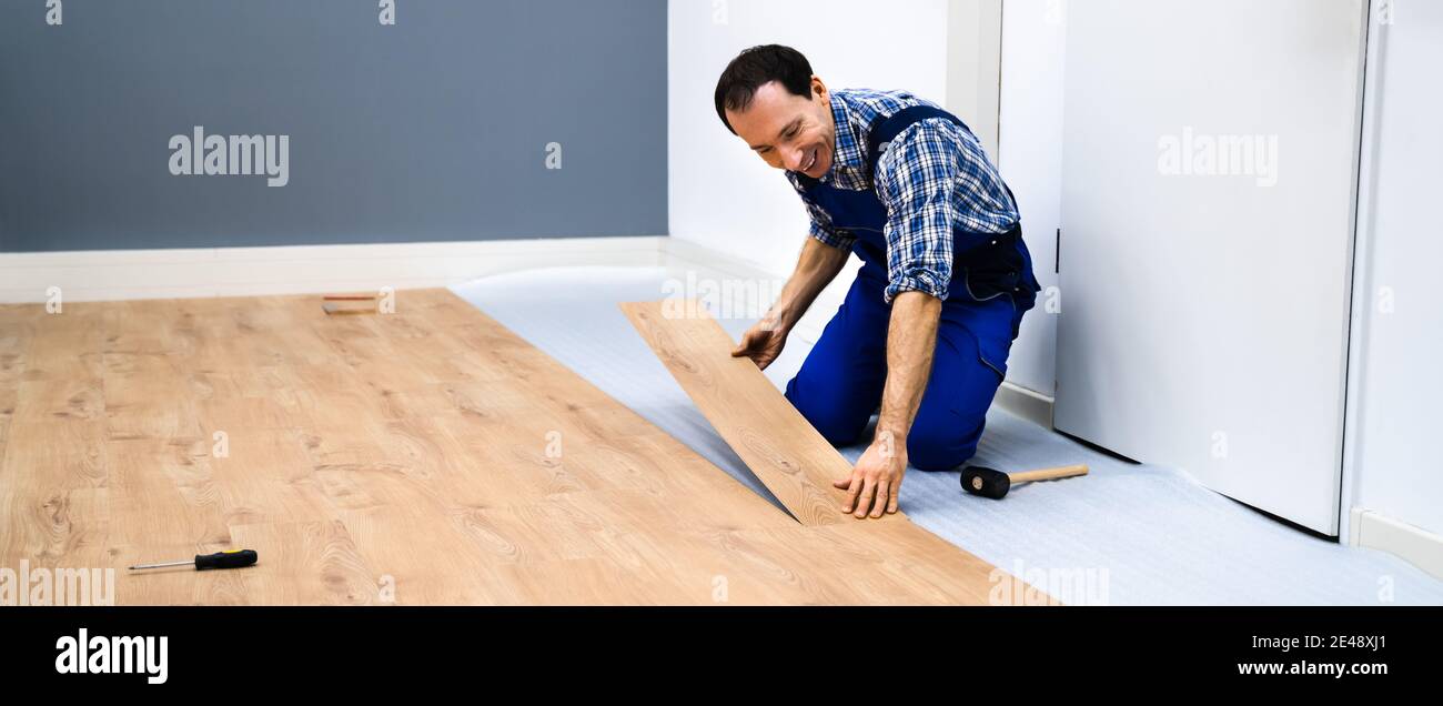 Hardwood Floor Renovation. Construction Worker Doing New Laminate ...