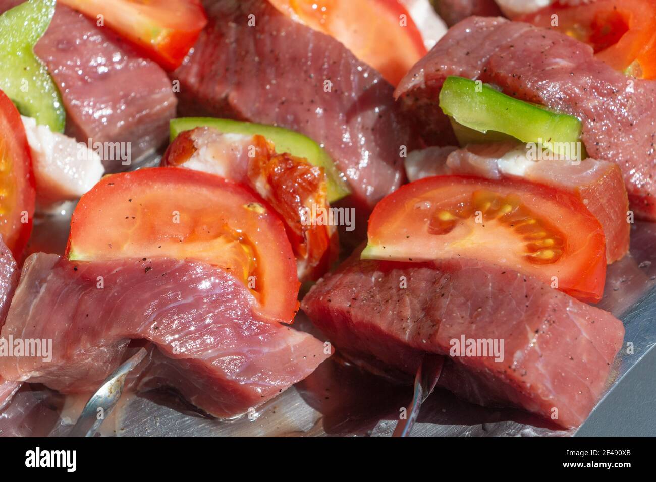 Raw beef and vegetables brochettes on a dish Stock Photo - Alamy