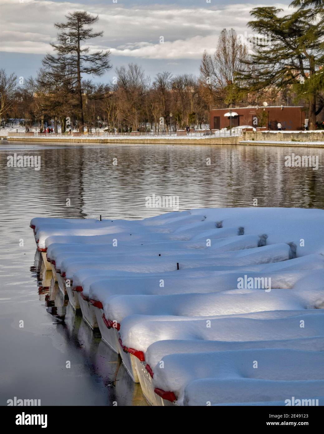 Vertical shot of a calm pond with snow-covered jetty Stock Photo - Alamy