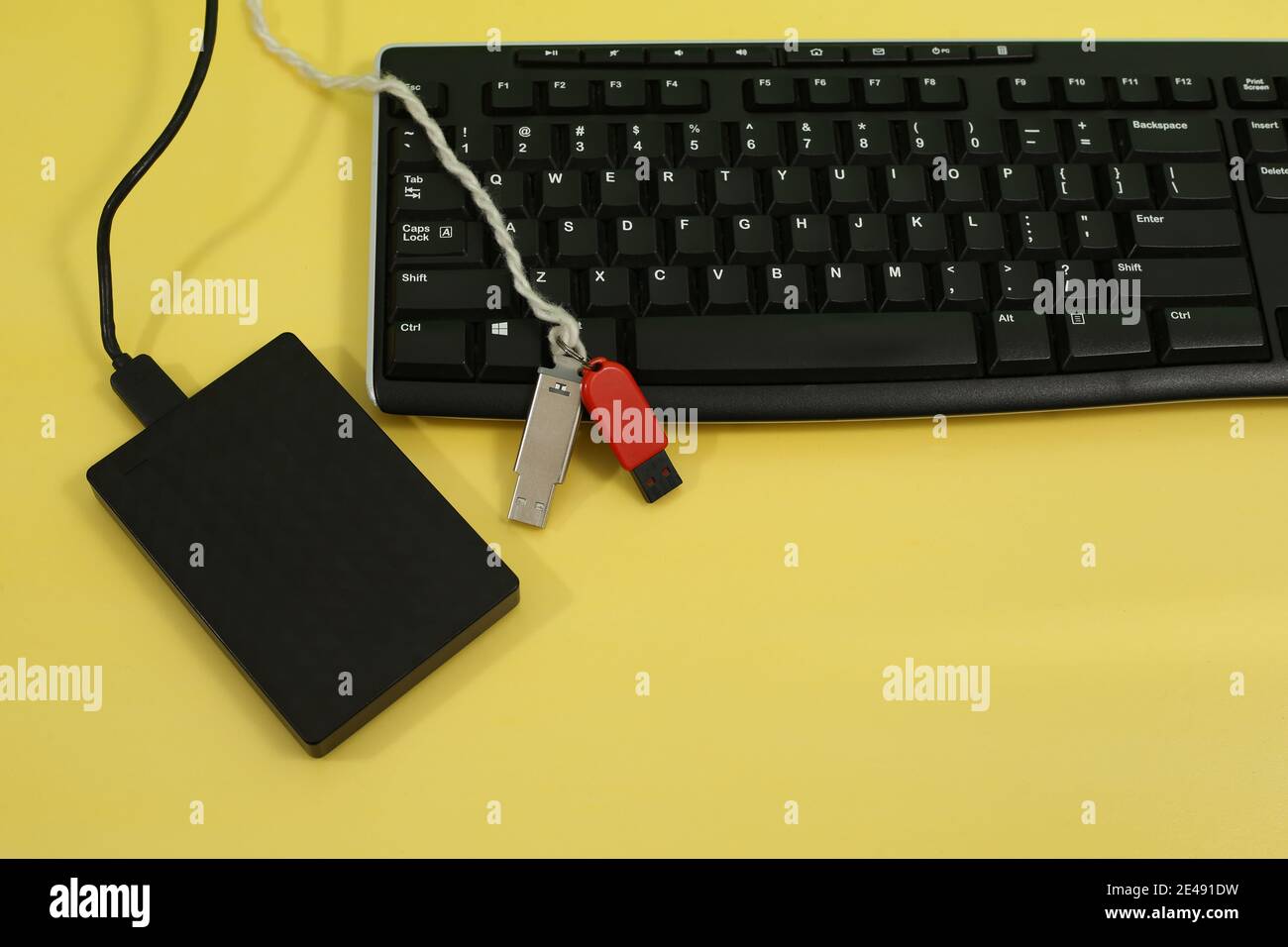 Computer keyboard, external hard drive, and USB flash drive displayed ...