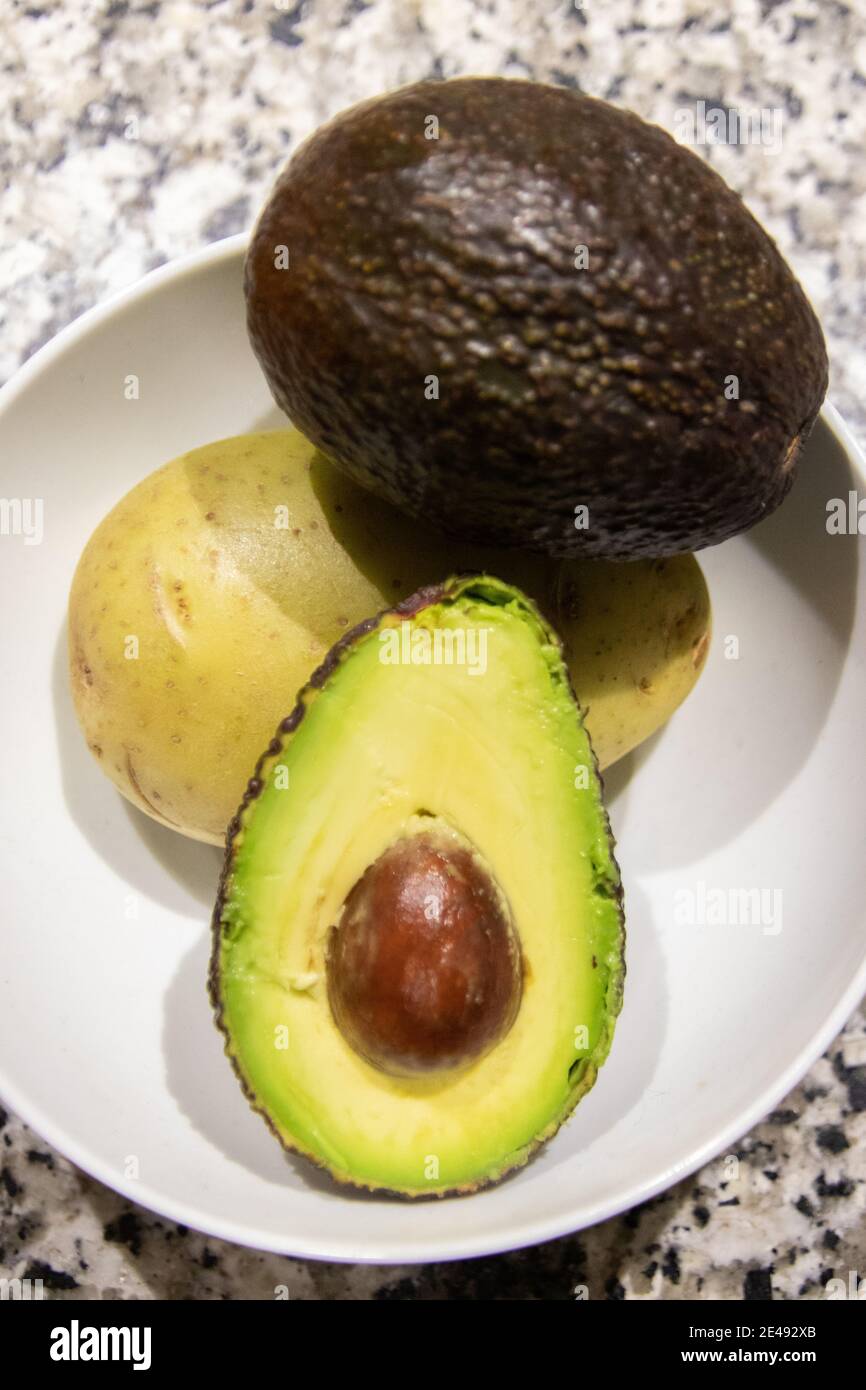 Isolated halved green avocado in a kitchen Stock Photo - Alamy
