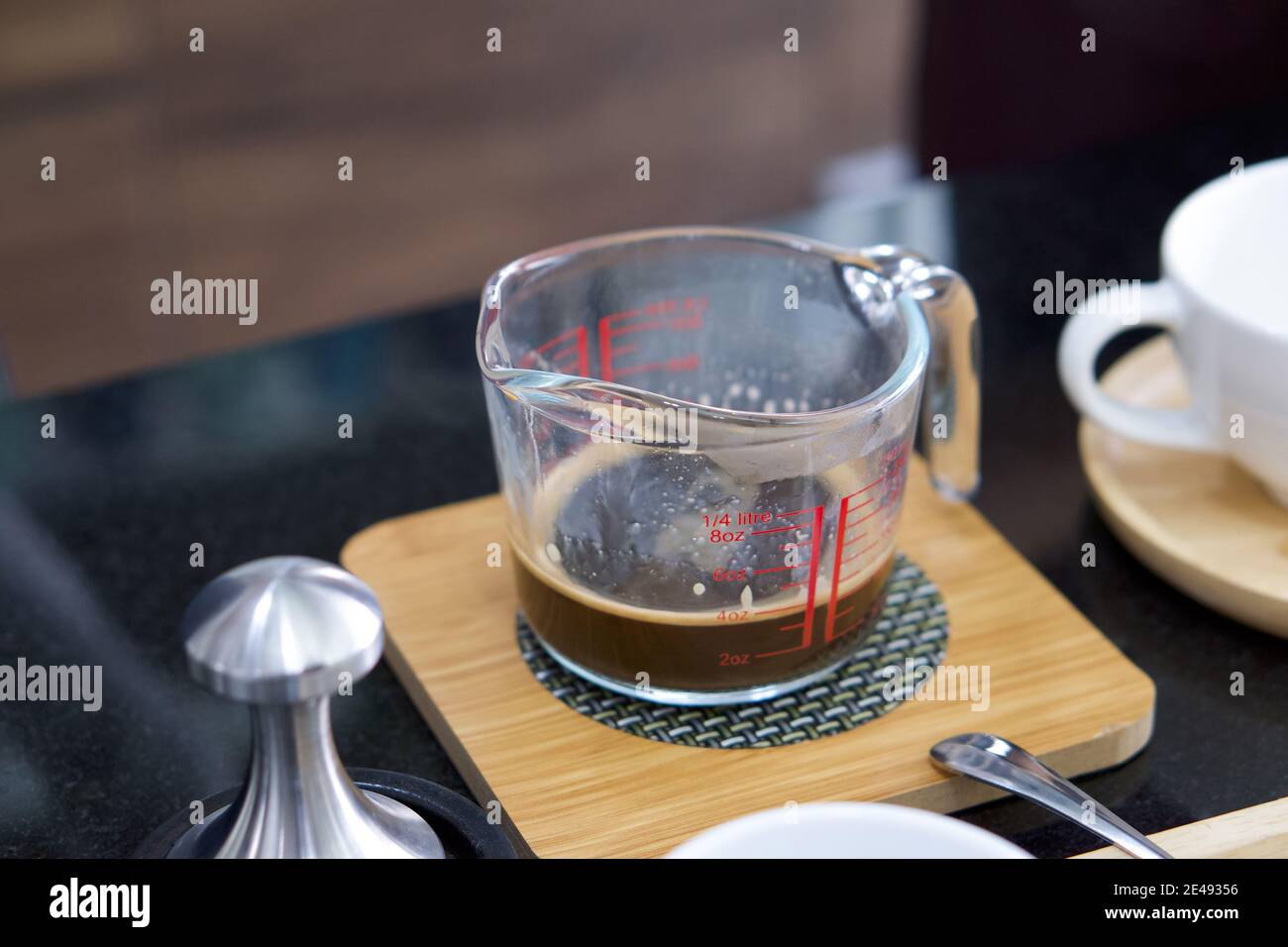 Closeup coffee in measuring cup on kitchen counter Stock Photo - Alamy