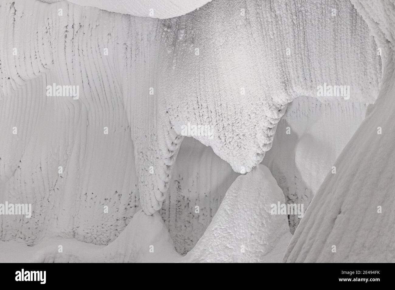 White embossed walls of ice and snow in a cave. Abstract textured ...