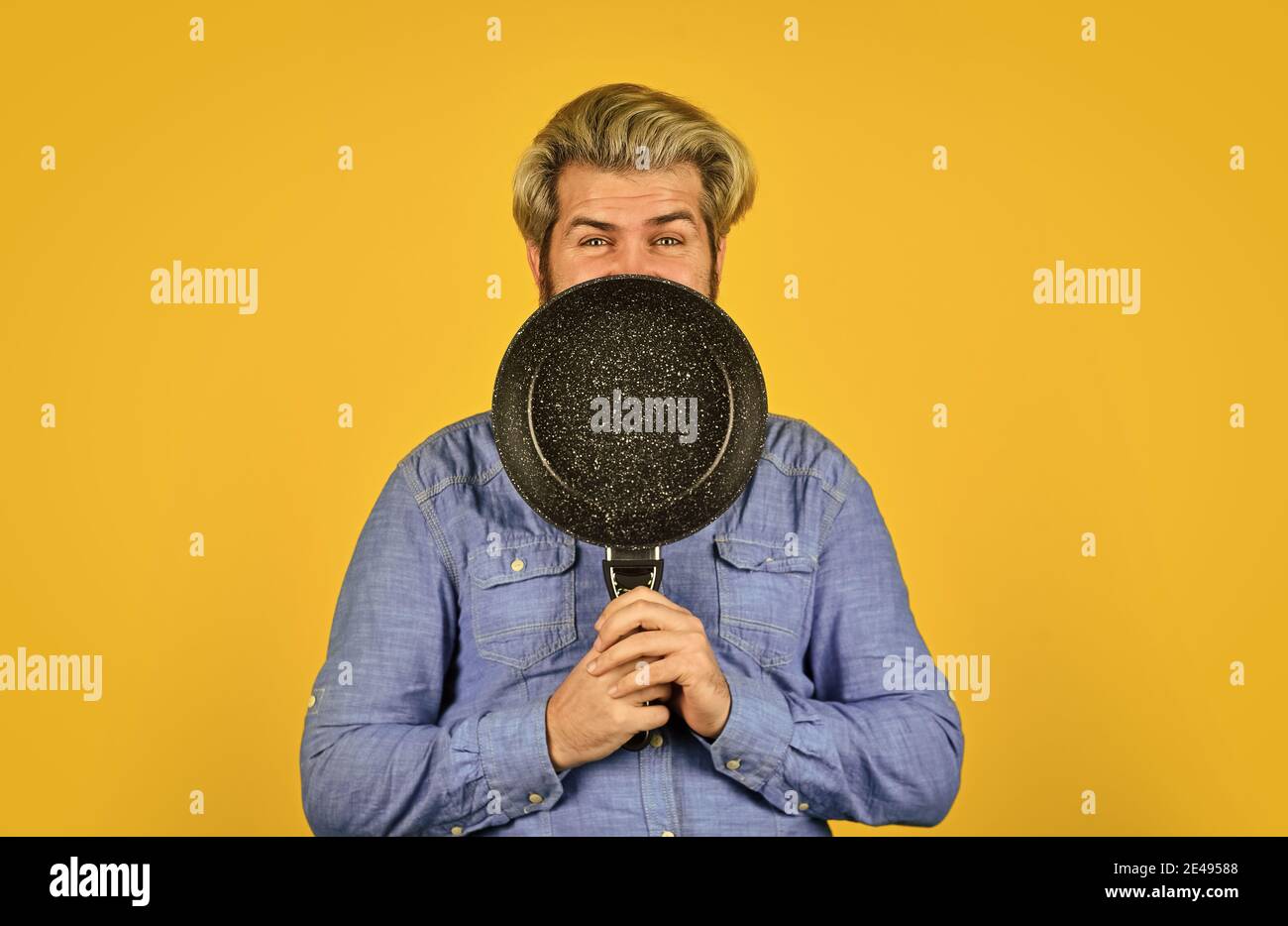 Nonstick pan porcelain surface. Man hold pan. Frying meal. Cooking ...