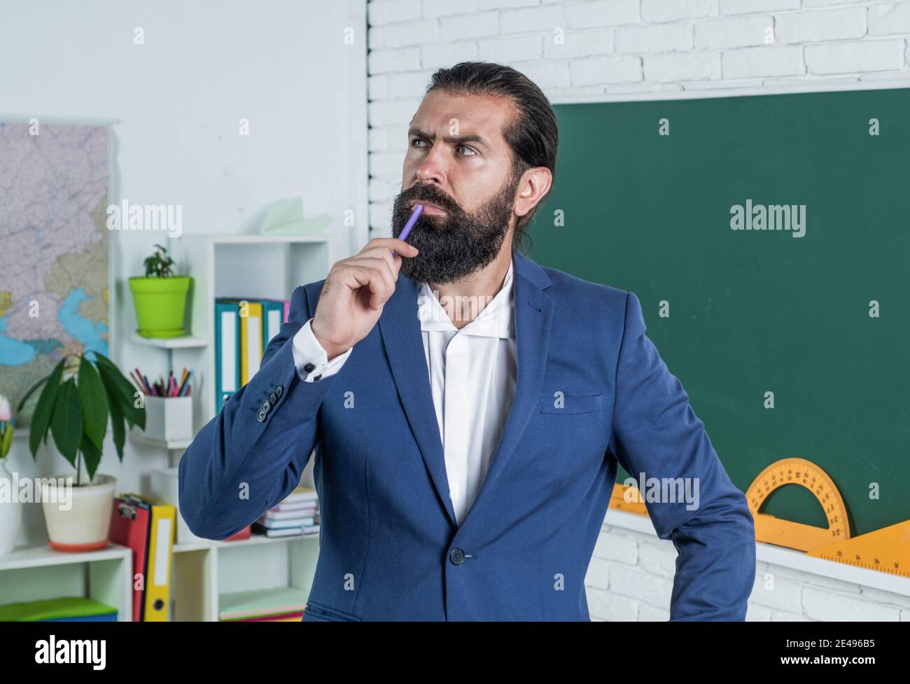 mature bearded man teacher in costume in school classroom with ...