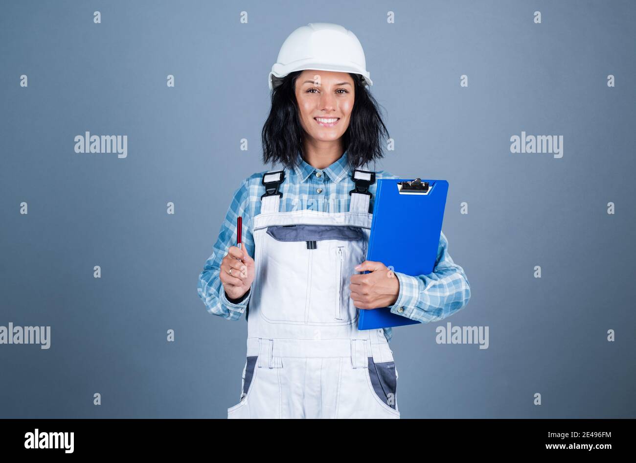builder assistant repair and fix. female worker in working uniform ...