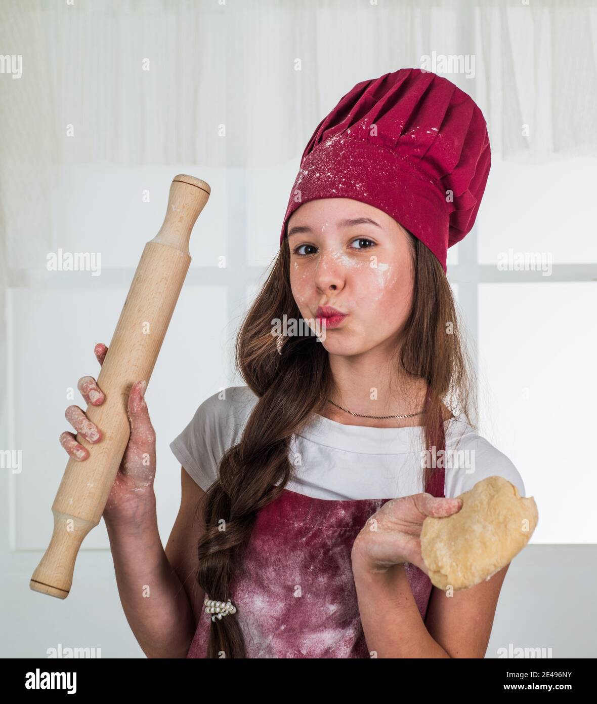 teen girl in cook uniform prepare food in kitchen, culinary Stock Photo ...