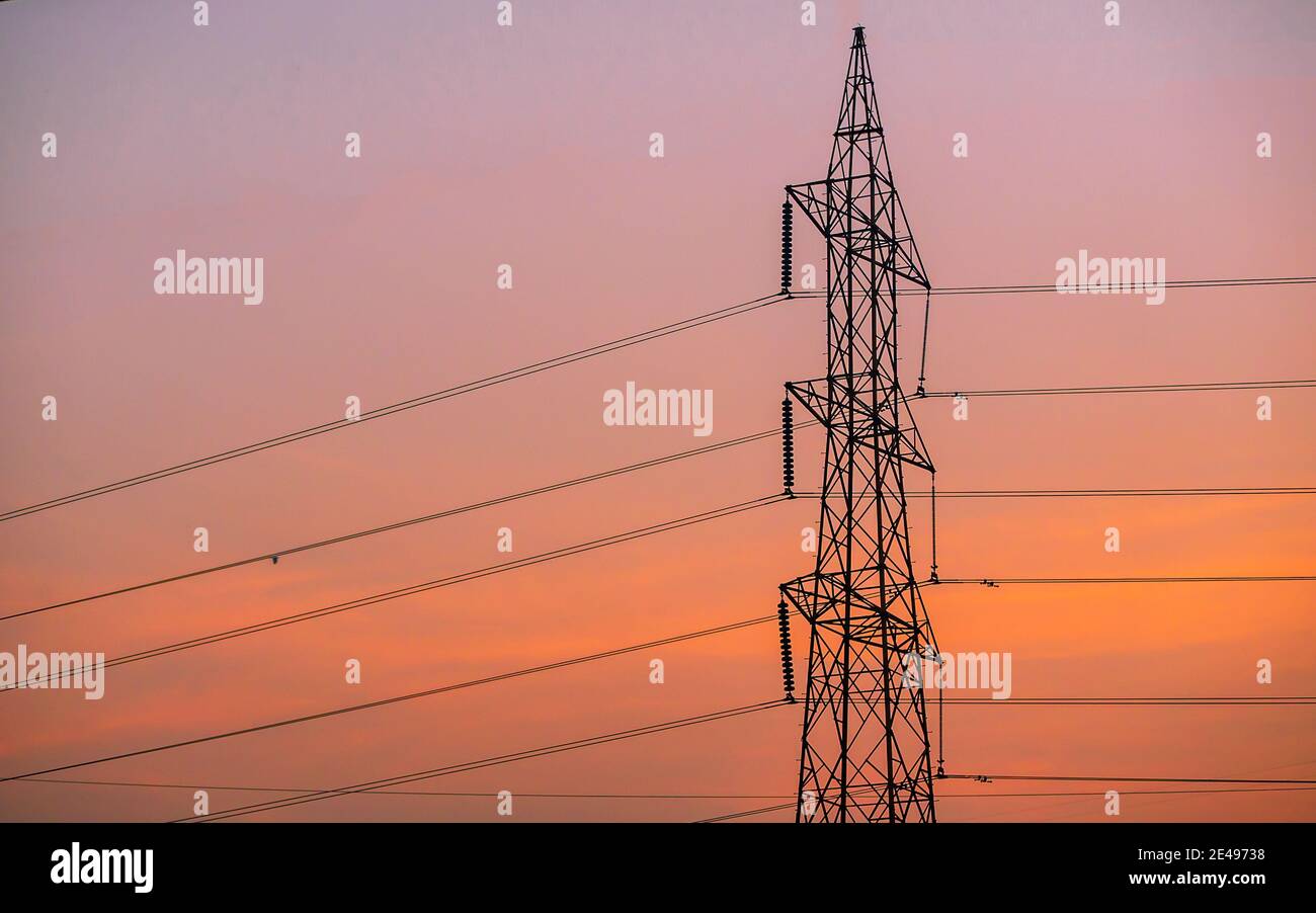 High-voltage power lines at Sunrise. Electricity distribution station ...