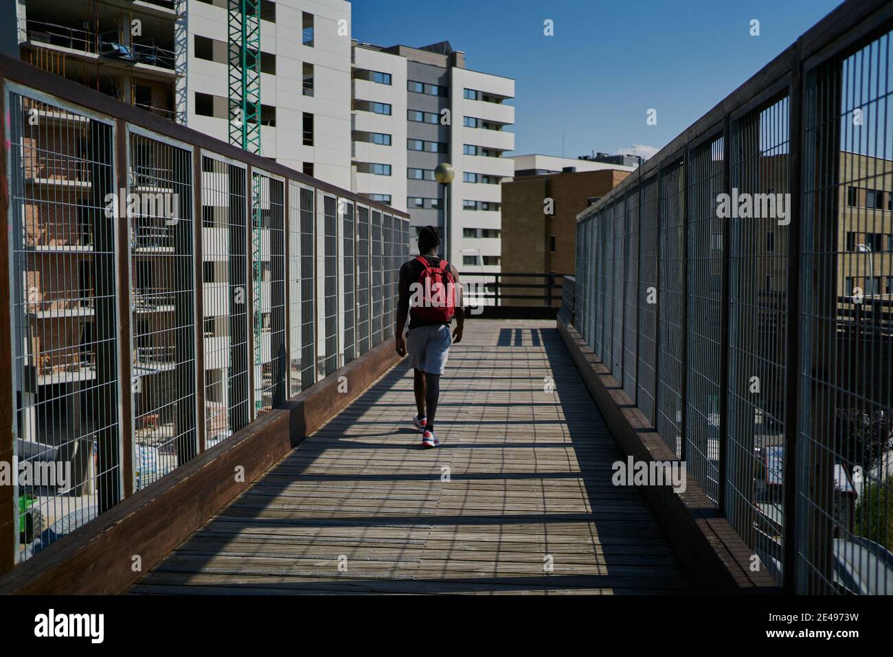 Man bridge walking away rear view hi-res stock photography and images ...