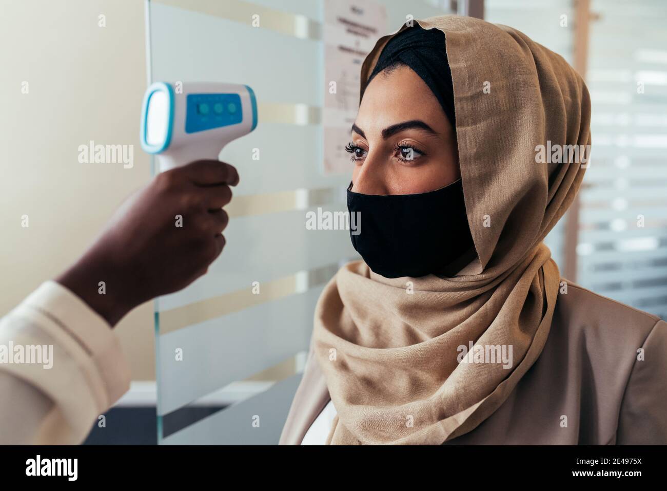 Woman having temperature check Stock Photo - Alamy