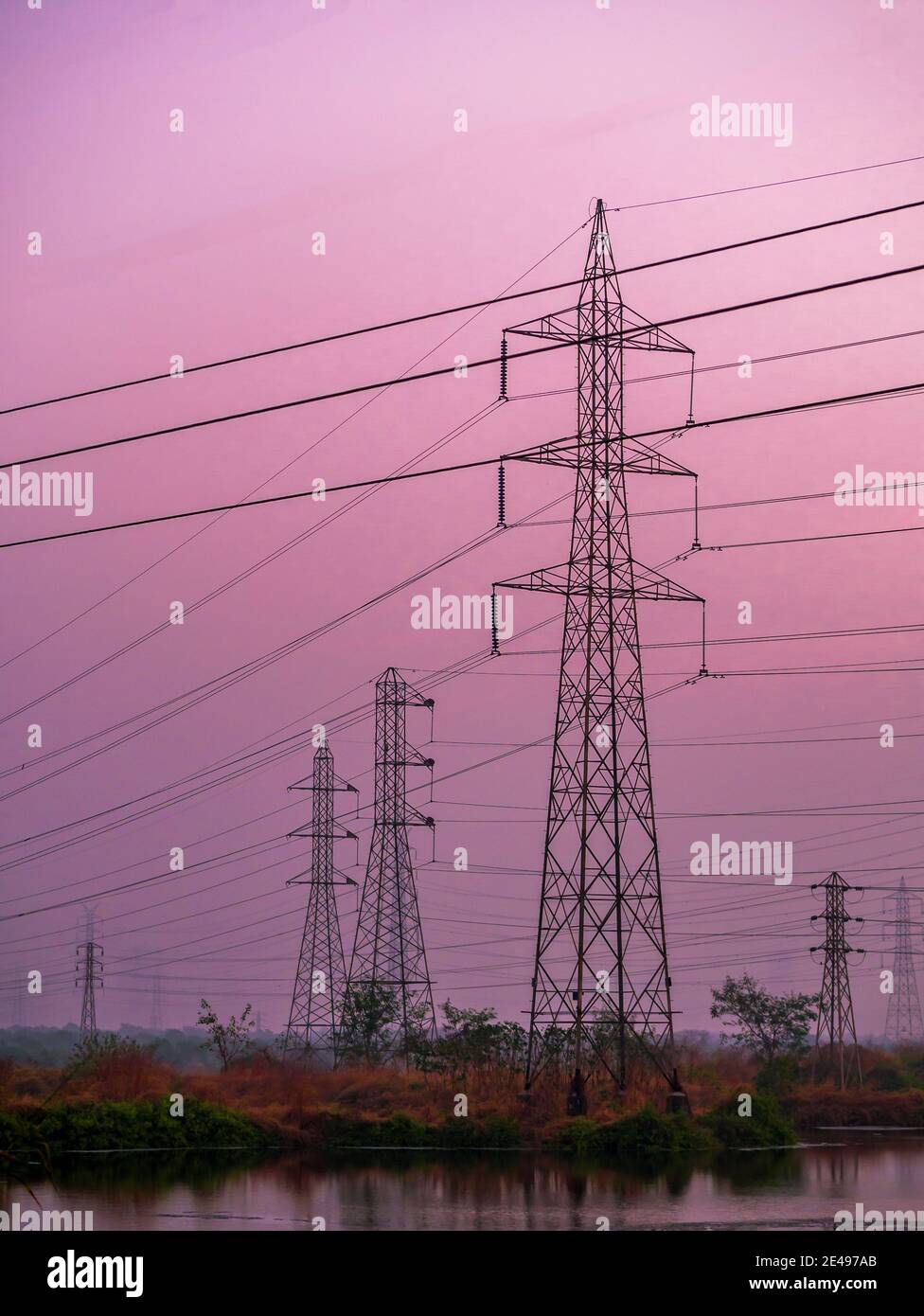 Reflection of High voltage power lines in Sea salt farm and barn at ...