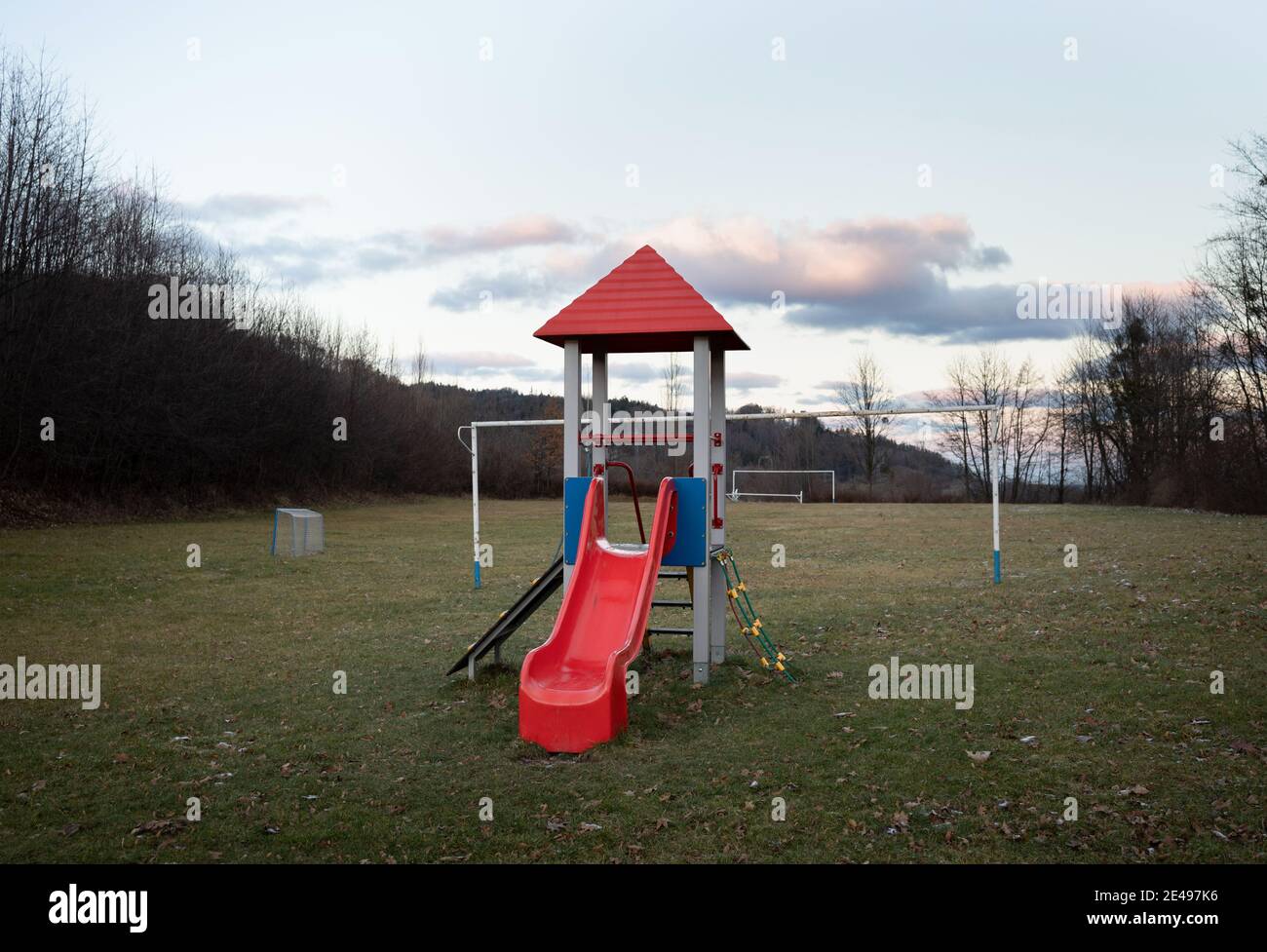 Playground and slide for children is empty in the evening. Football ...