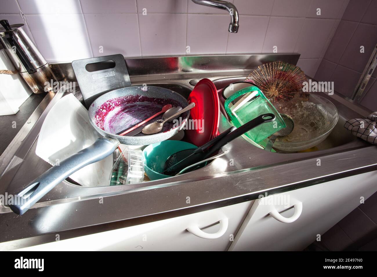 Dirty dishes to wash in the kitchen in the sink, natural light Stock ...