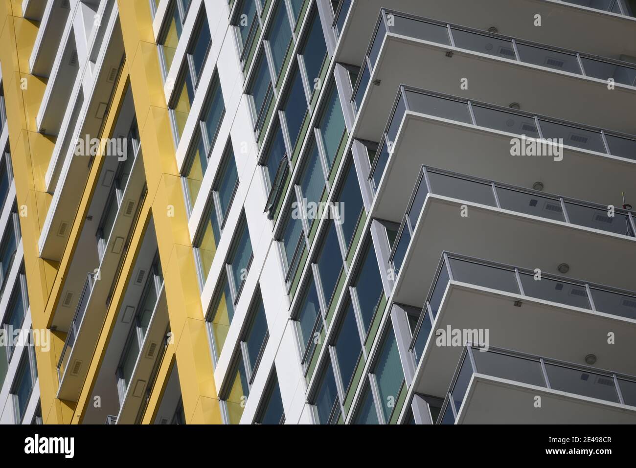 Residential high-rise complex building with white concrete balconies ...