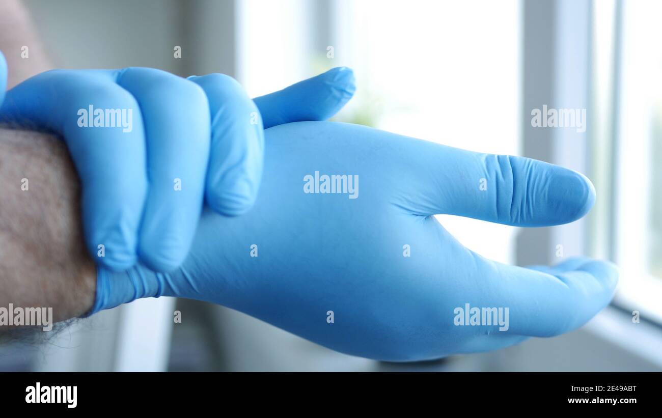 Nurse Puts Protective Gloves on Hands Fixing Them with Carefully ...