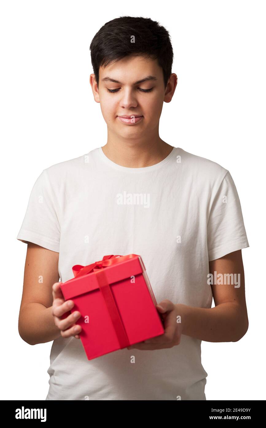 Handsome caucasian teen guy holding red gift box with both hands ...