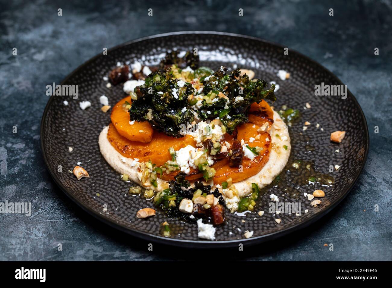 Butternut squash with cashew nuts puree, feta, kale and chillis Stock ...