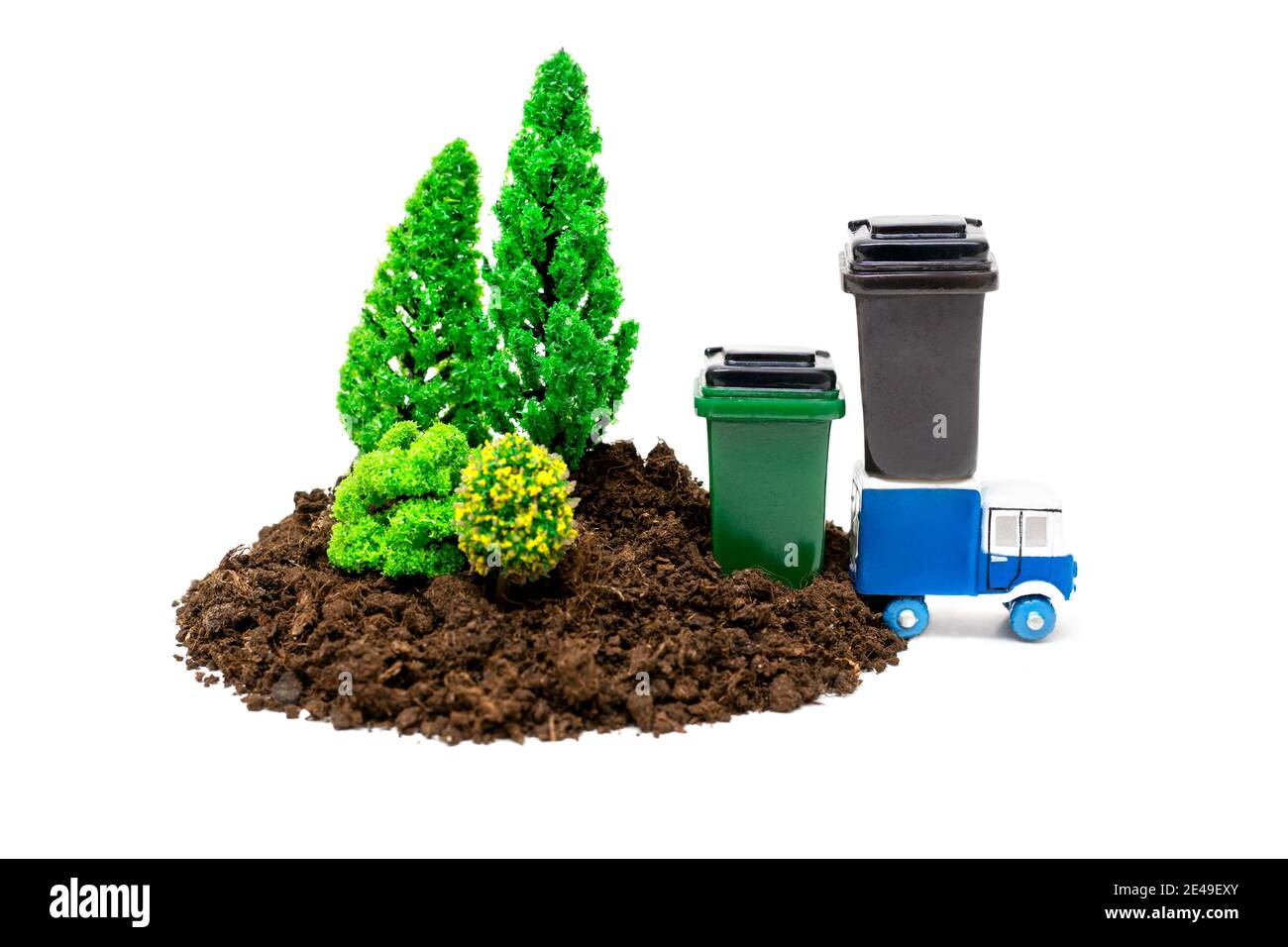 Toy trees and trash containers with a garbage truck isolated on white ...