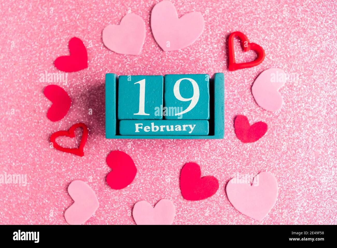 February 19. Blue cube calendar with month and date and decorations on ...