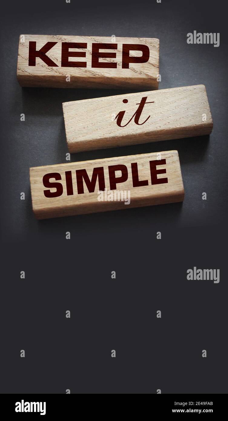 Keep it simple words on wooden blocks on dark gray background. Business ...