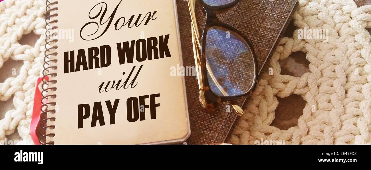 Conceptual text Your hard work will pay off message on a book with pen ...