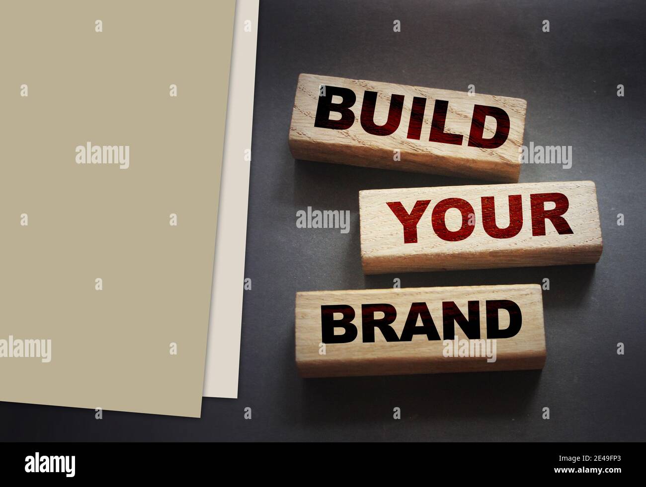 Build yor brand words on wooden blocks on black background. Marketing ...