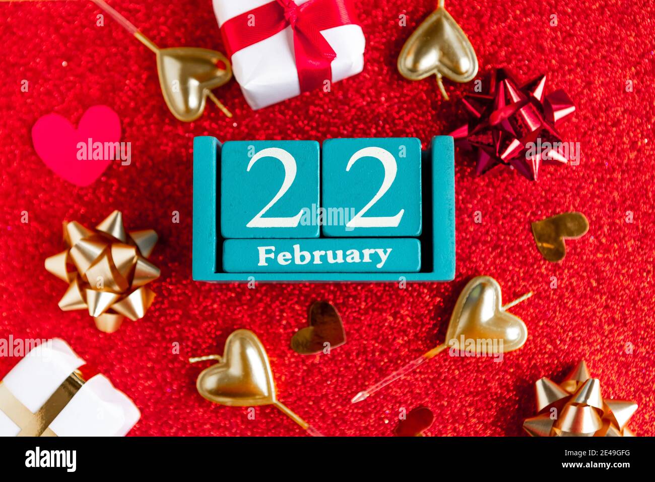 February 22. Blue cube calendar with month and date and decorations on ...