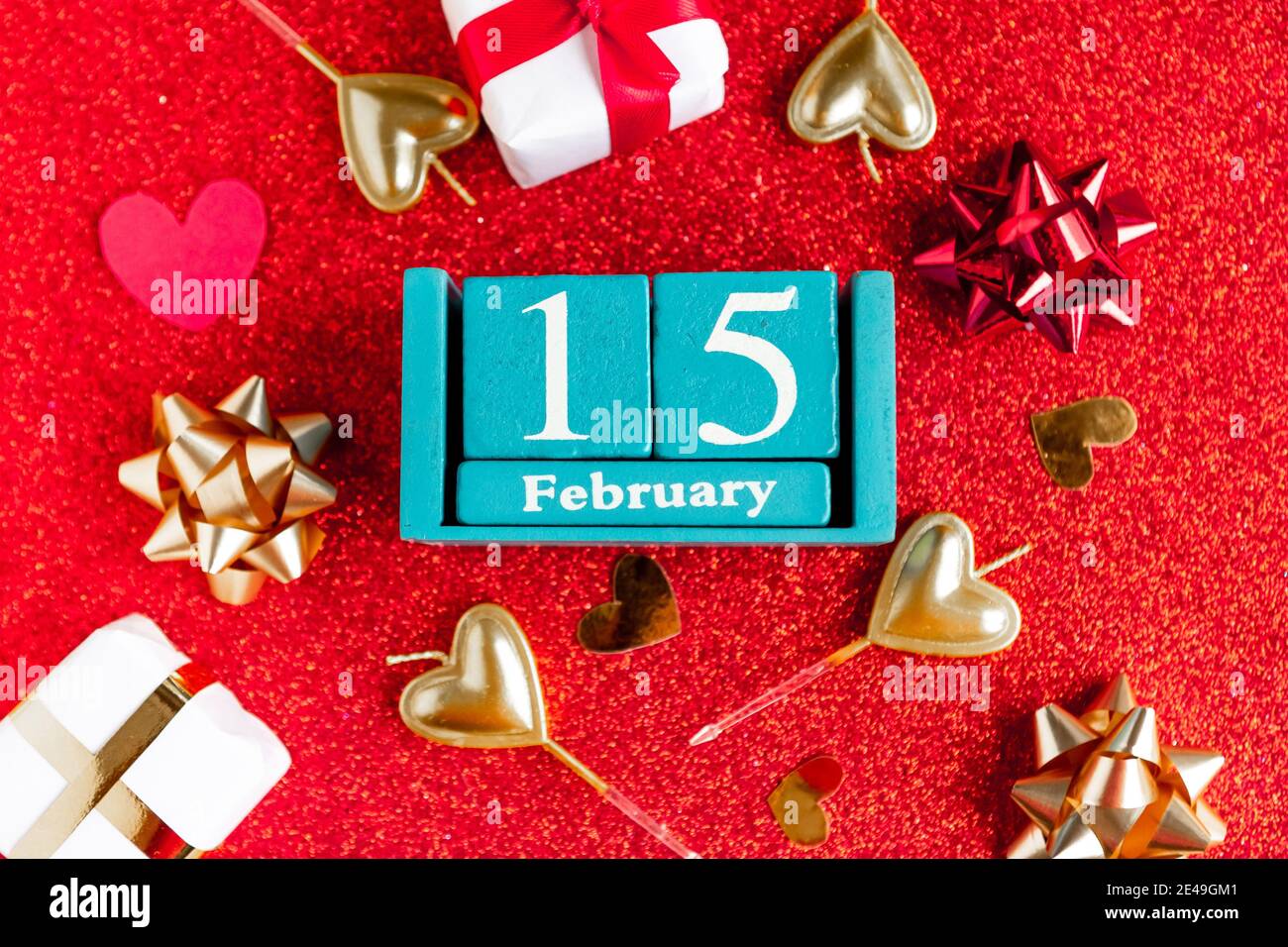 February 15. Blue cube calendar with month and date and decorations on ...