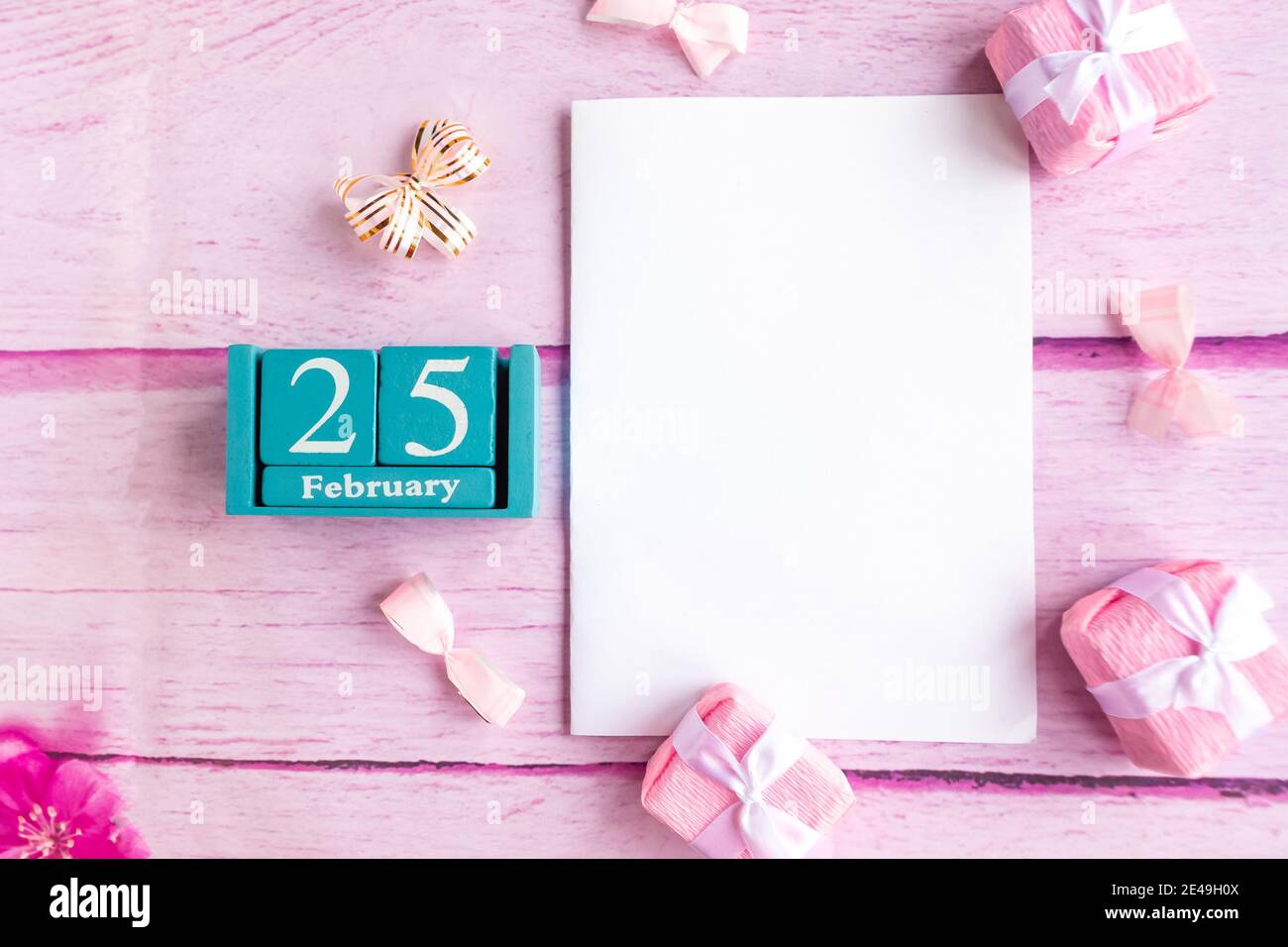 February 25. Blue cube calendar with month and date and white mockup ...