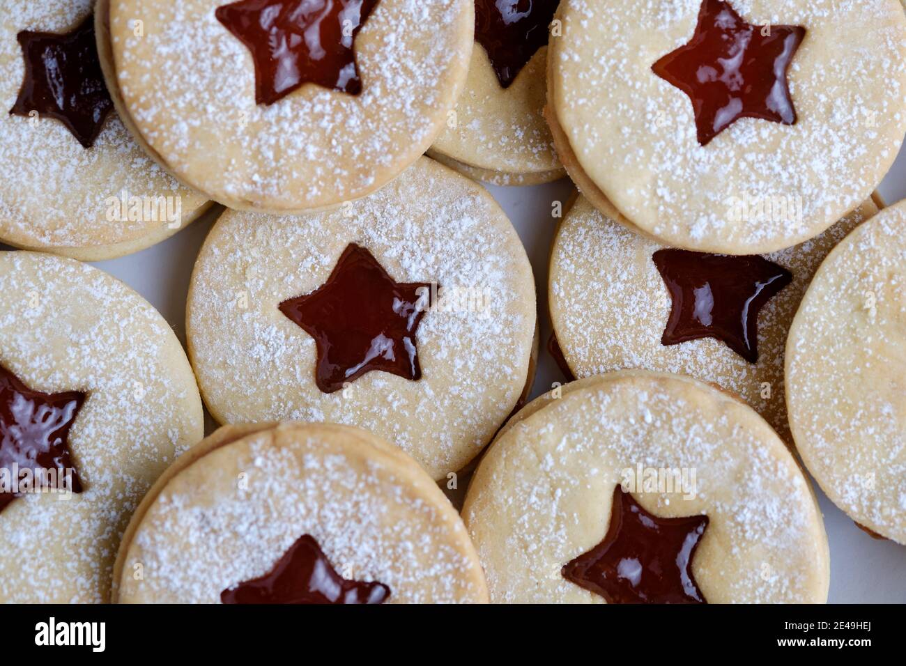 A close up picture of a plate of home made Jammy Dodgers biscuits. The ...