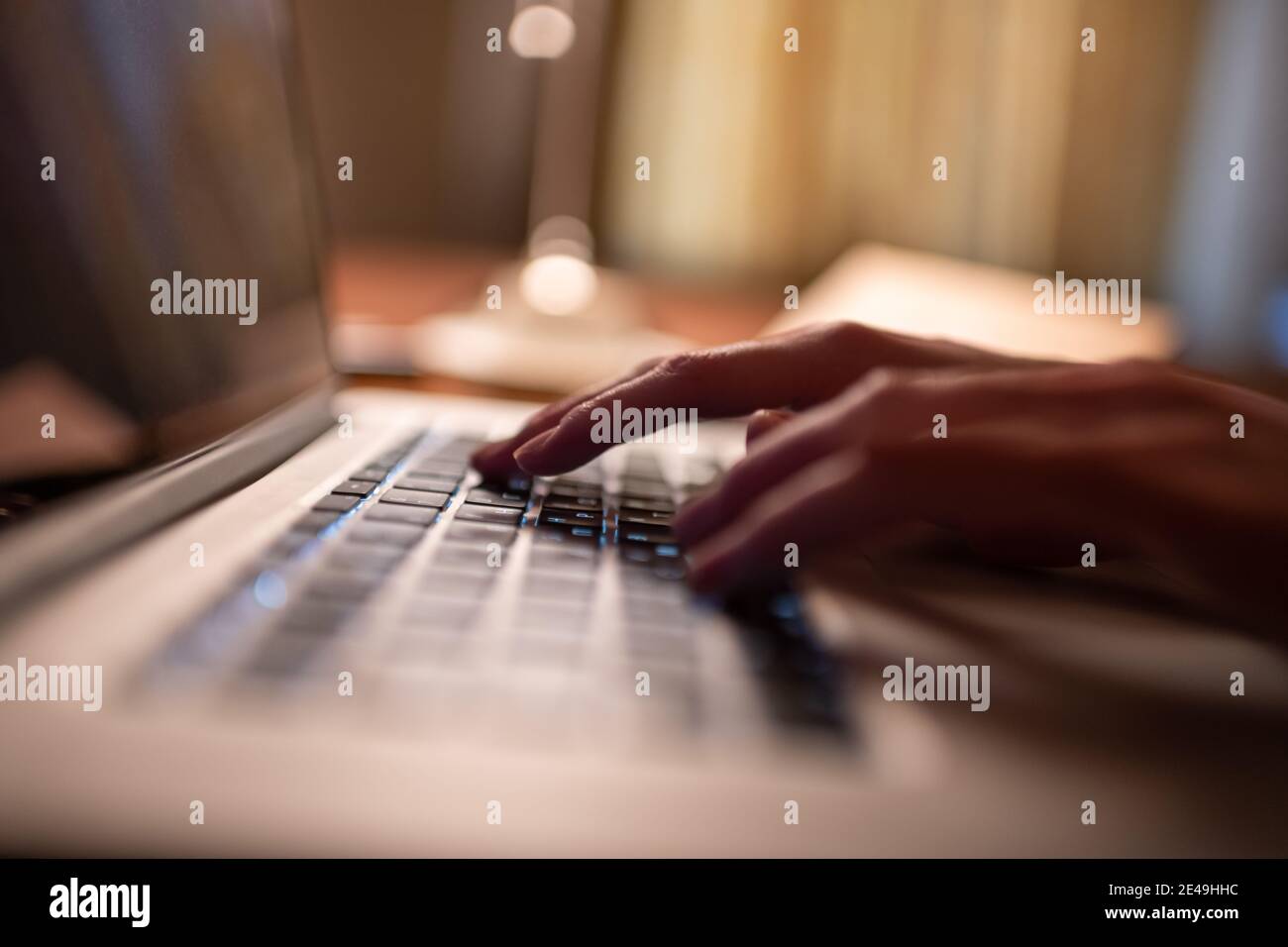 Anonymous woman typing on laptop keyboard while doing homework ...