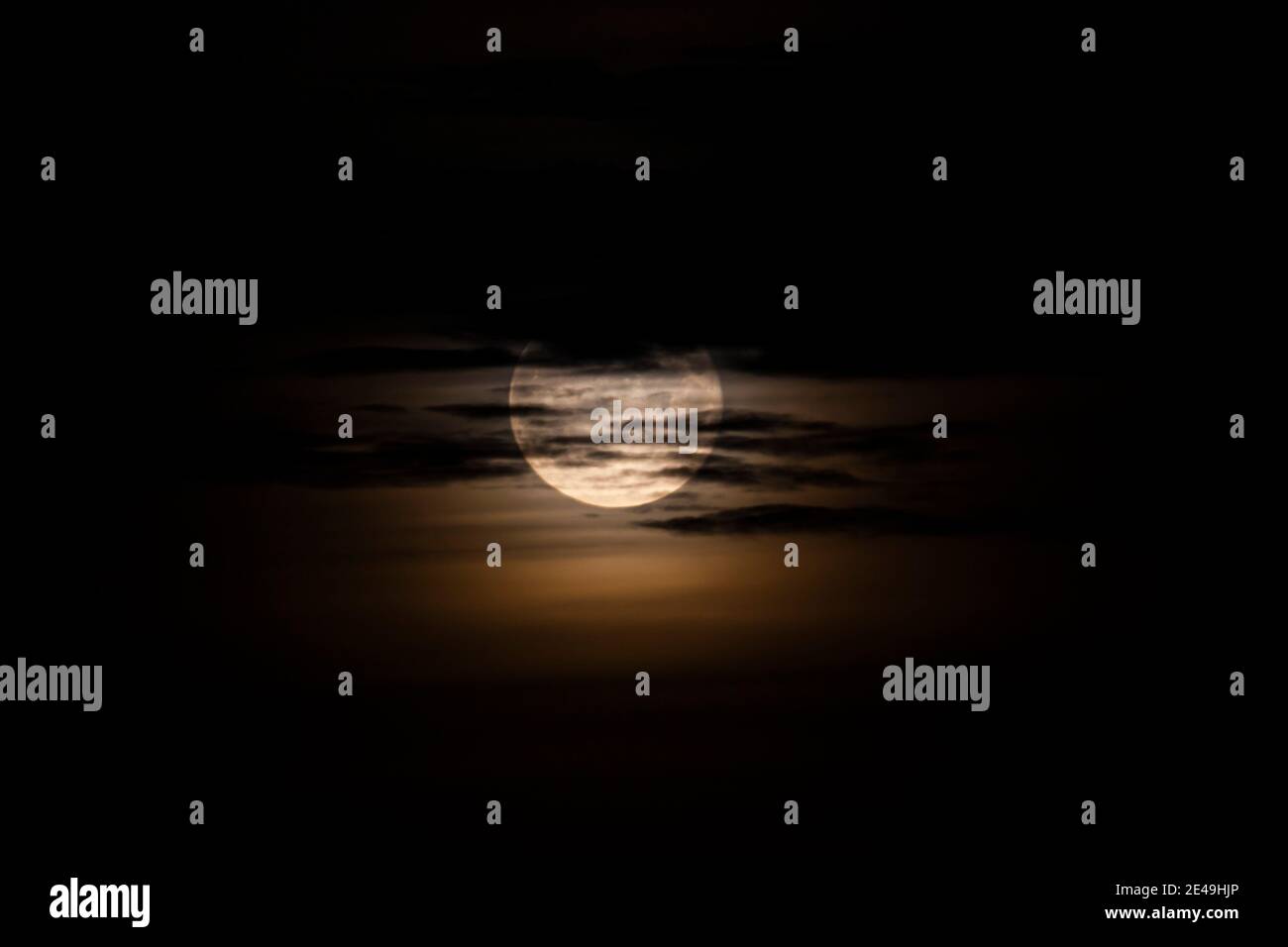 Moonlight through dramatic night clouds Stock Photo - Alamy