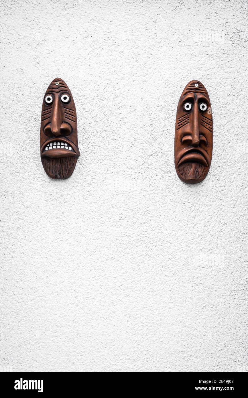 Two unique and cultural African wooden masks with surprised and sad ...