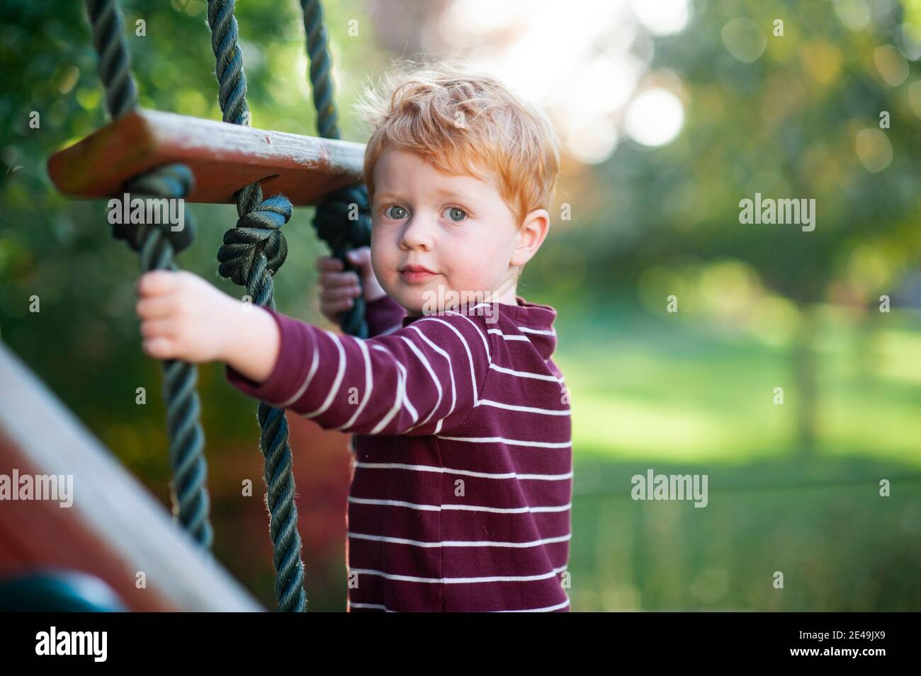 Boy climbing up ladder hi-res stock photography and images - Alamy
