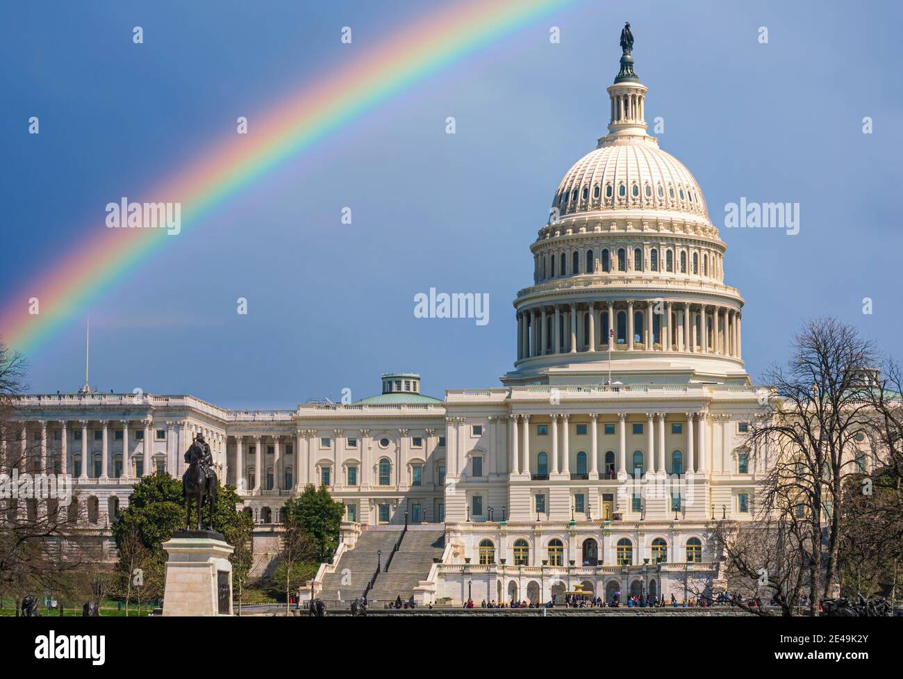 West side view of the United States Capitol building under a rainbow ...