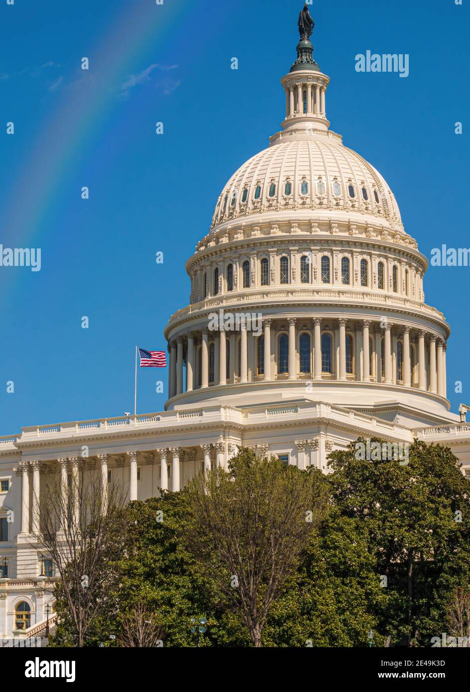 West side view of the United States Capitol building under a rainbow ...