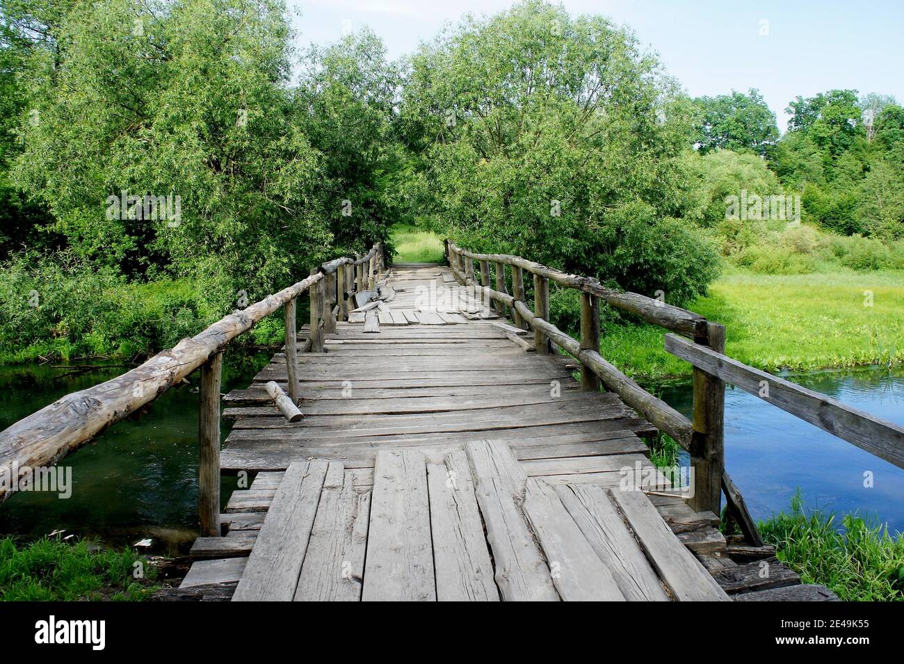 old wooden bridge across the river Stock Photo - Alamy