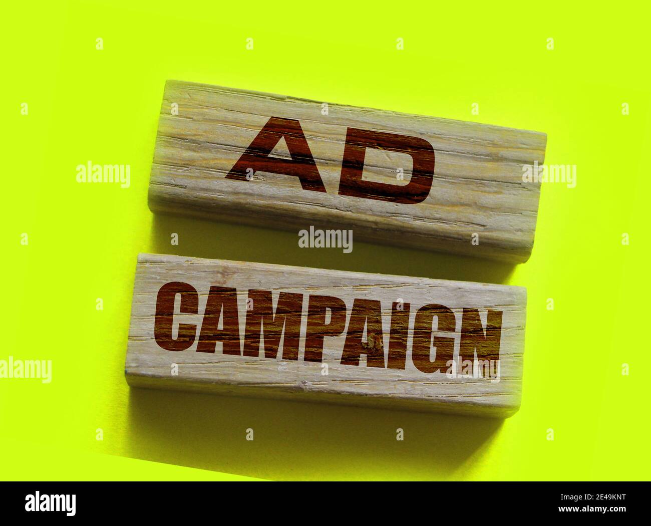 Ad Campaign on Wooden Blocks on yelow background. Marketing advertising ...