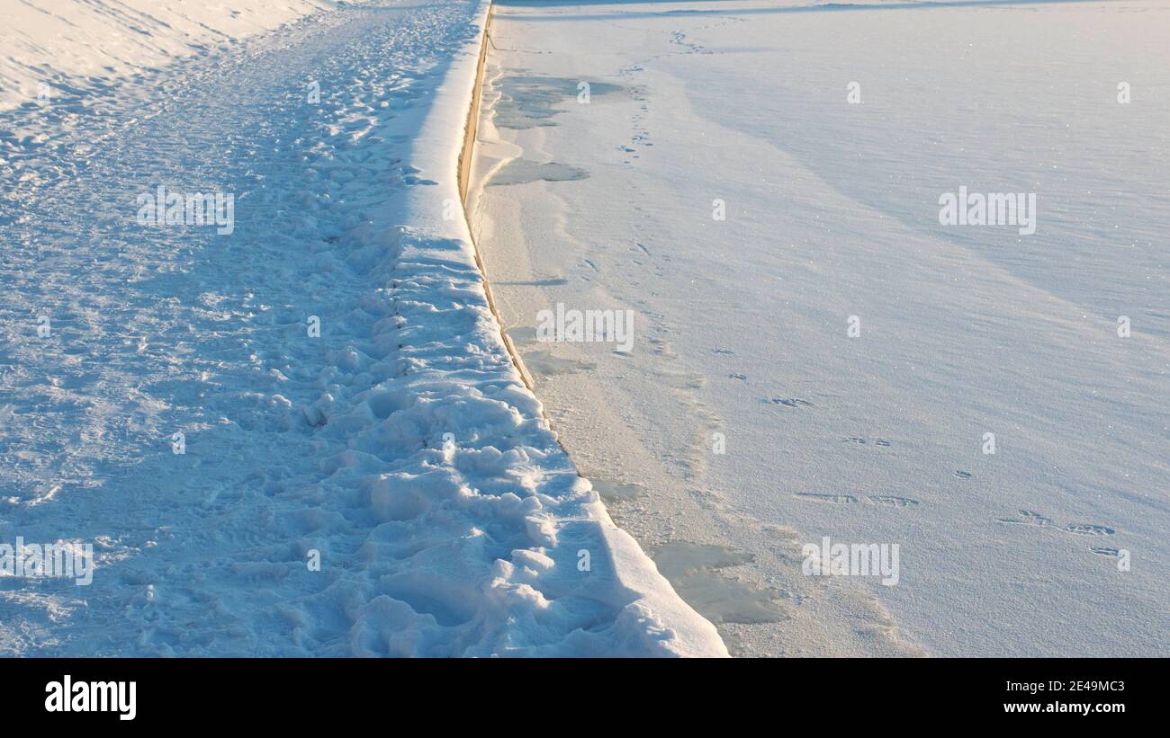 Frozen river, with a beautiful walking path, winter cold, snowy ...