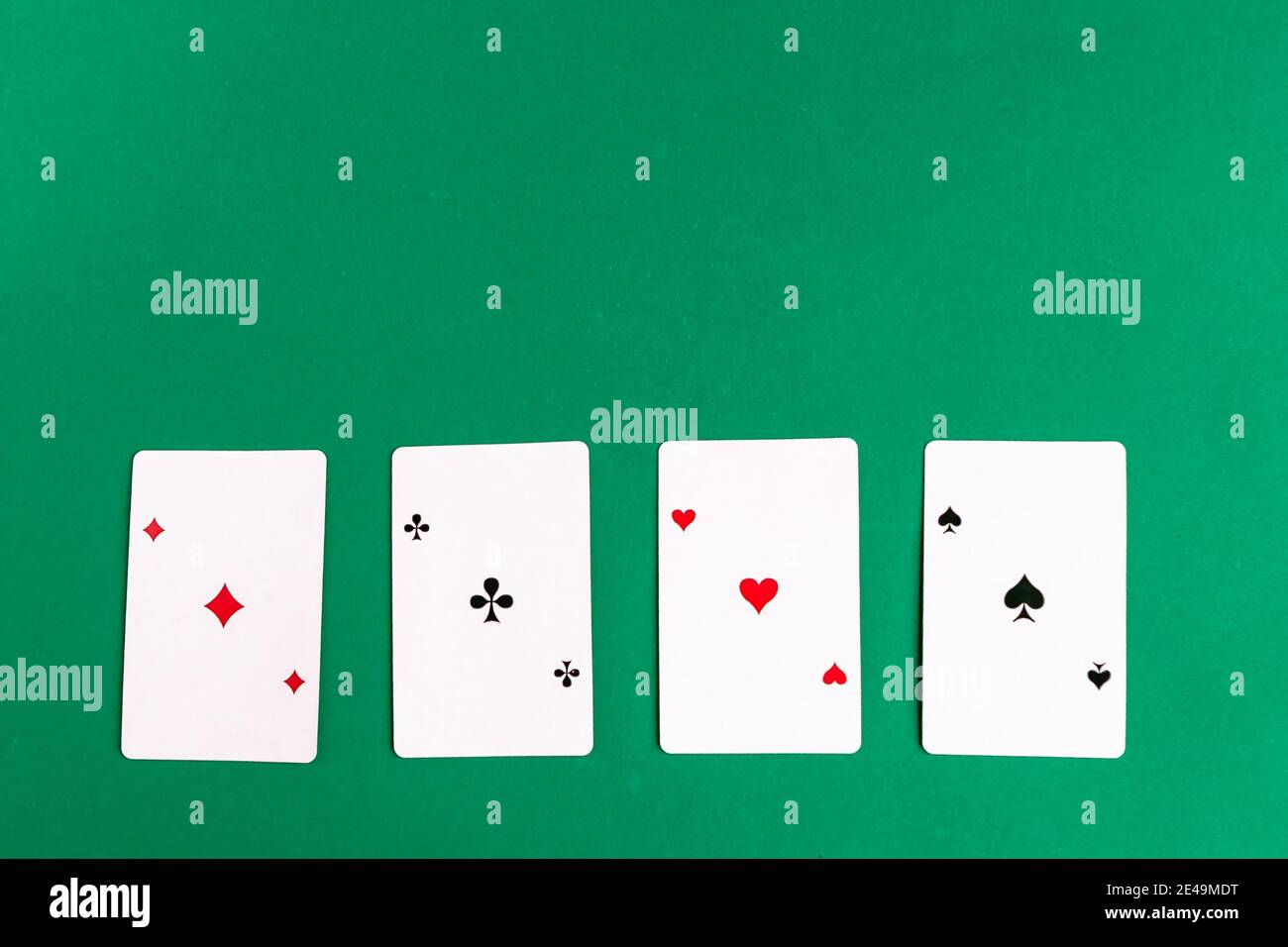Poker quads playing card, green background Stock Photo - Alamy