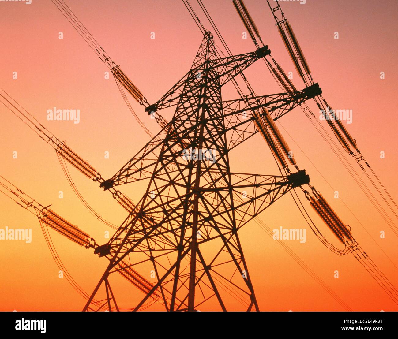 Low angle view of electricity pylon tower pylons towers against sunset ...