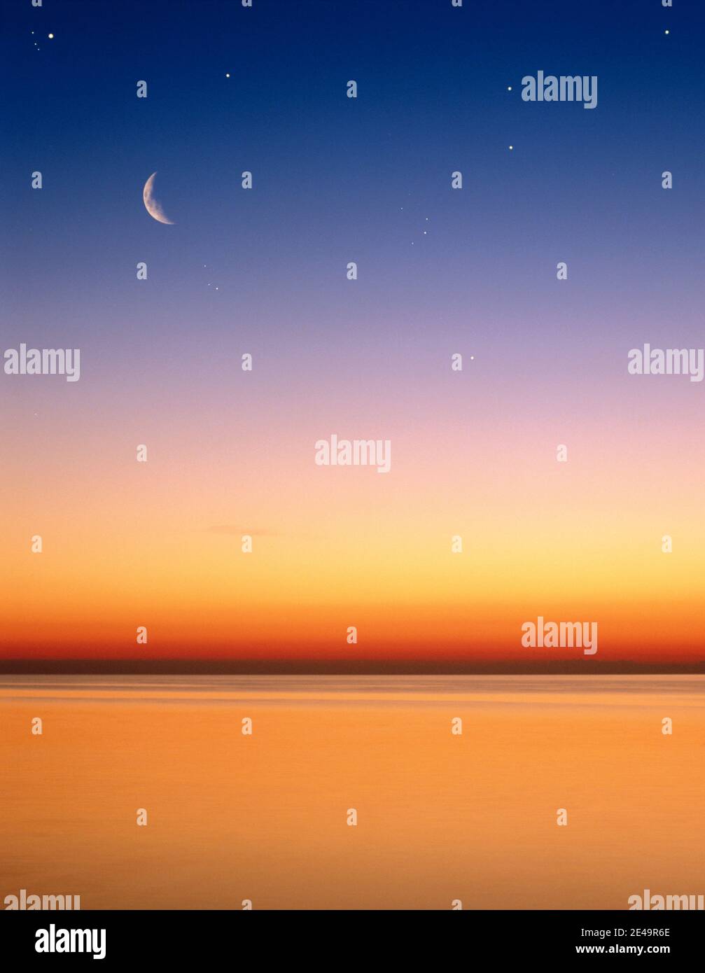 crescent moon with stars in blue and orange sky over sea, ocean, calm ...