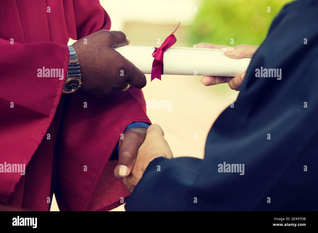 Graduate Receiving Diploma and Handshake Stock Photo - Alamy