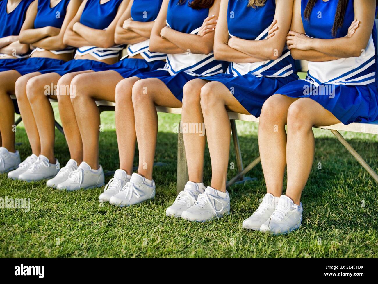 Photo of cheerleaders sitting on bench Stock Photo - Alamy