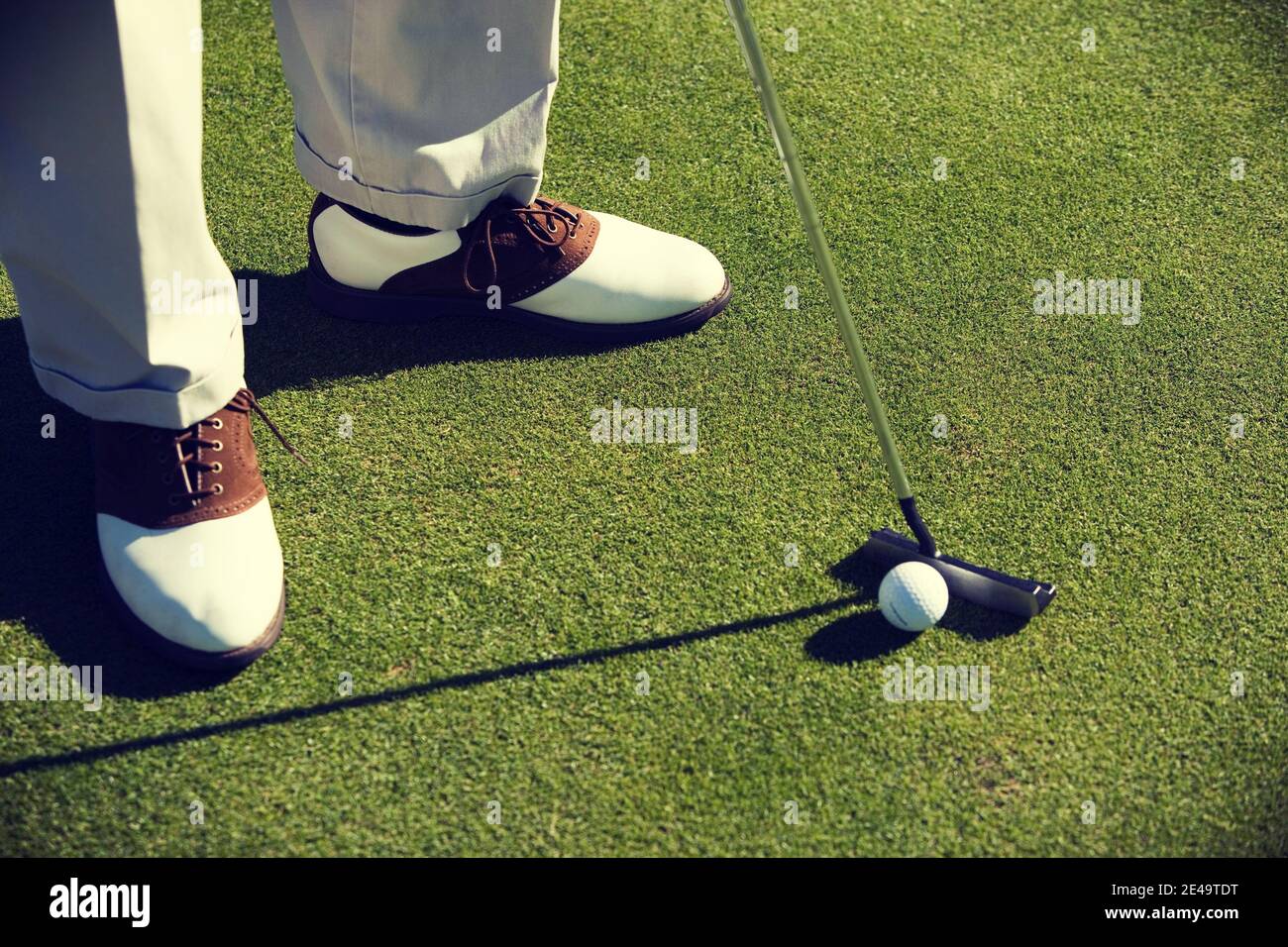 Close up photo of Man Putting Golf Ball Stock Photo - Alamy