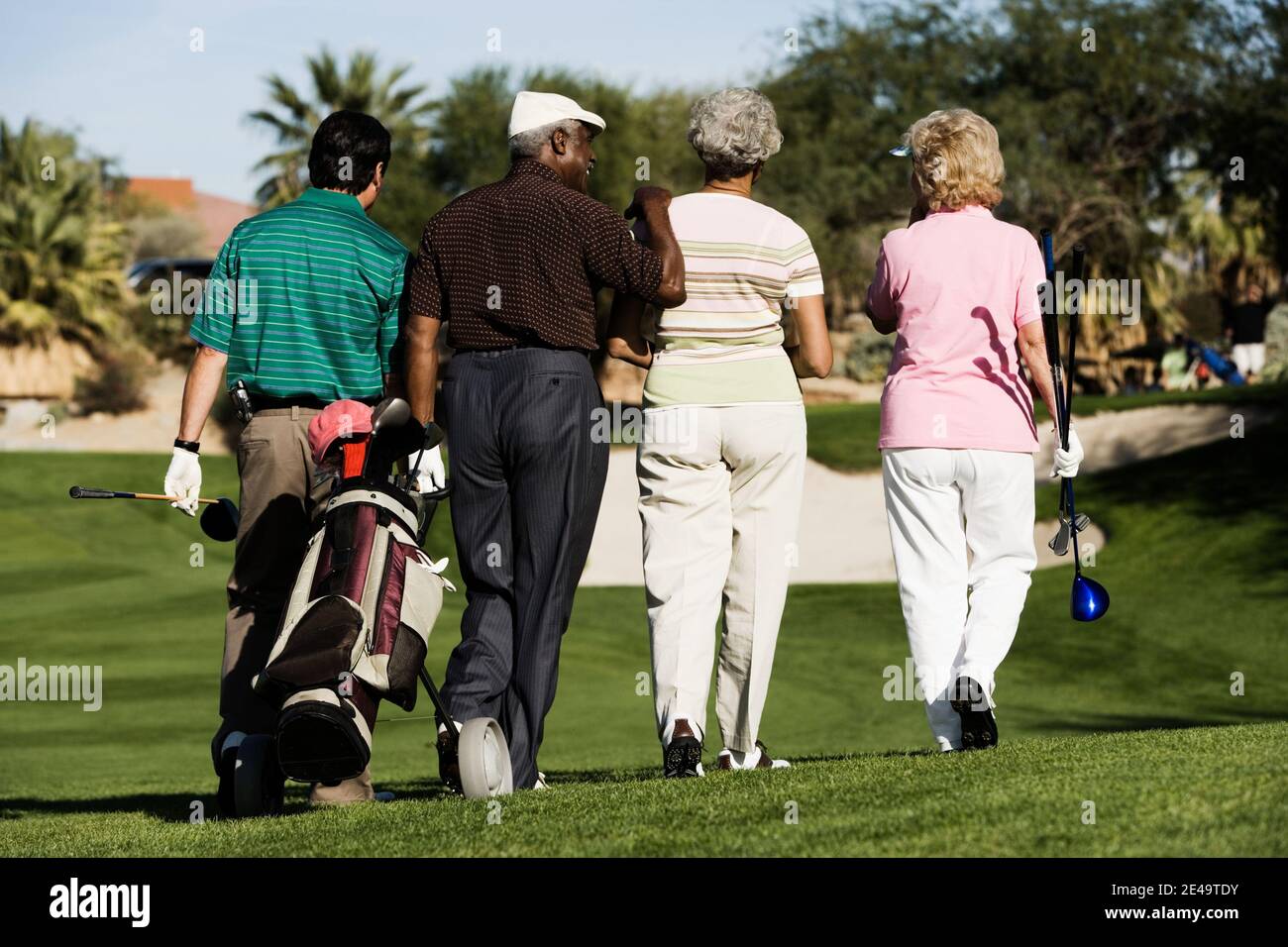 Happy friends walking at golf course 20s adult hi-res stock photography ...