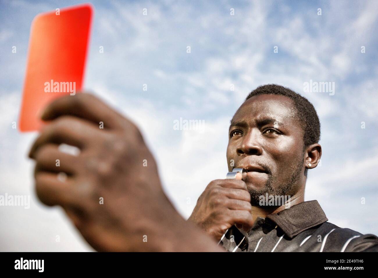 Soccer Referee Holding Out a Red Card Stock Photo - Alamy