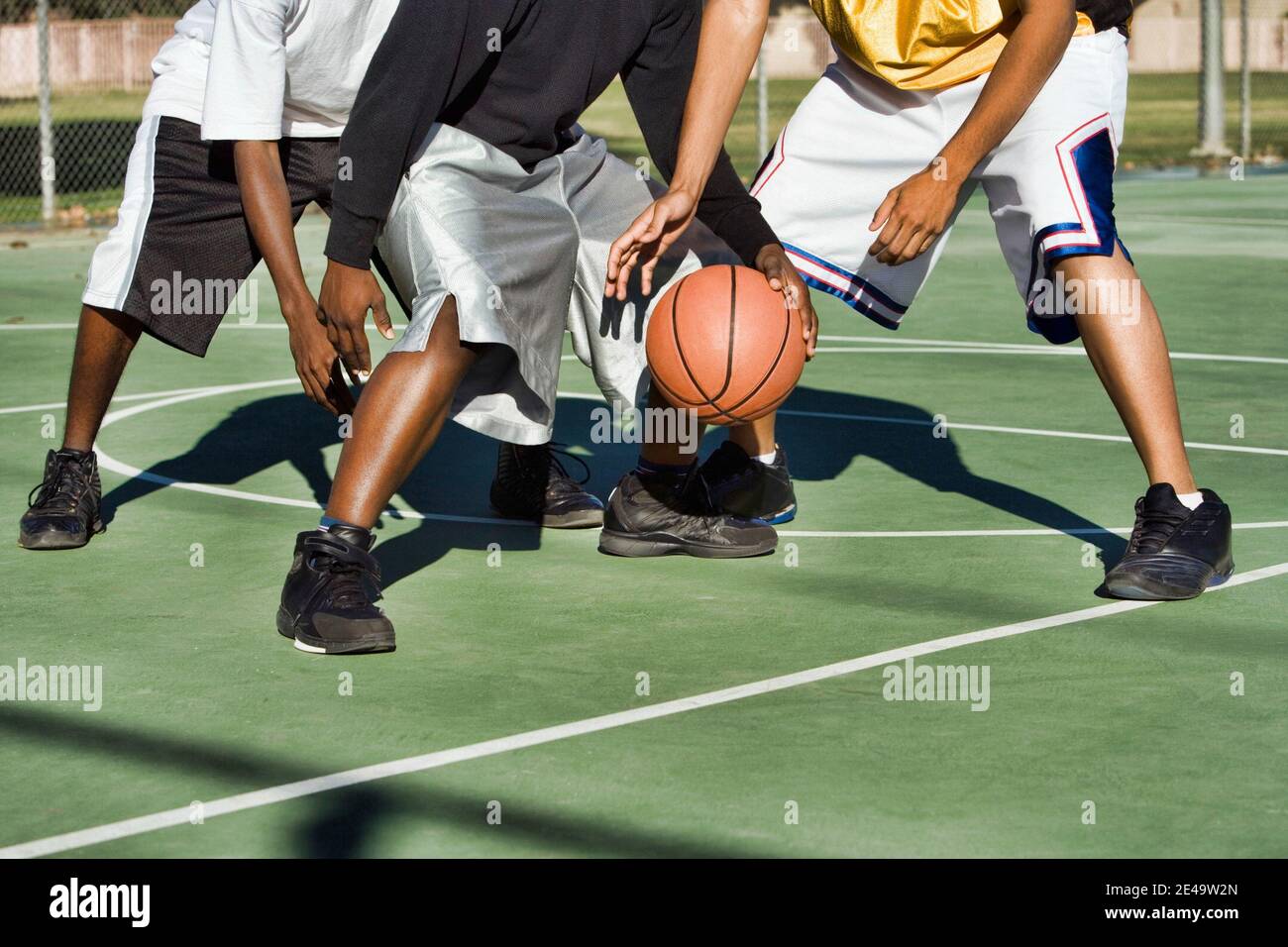 Basketball players playing in court Stock Photo - Alamy