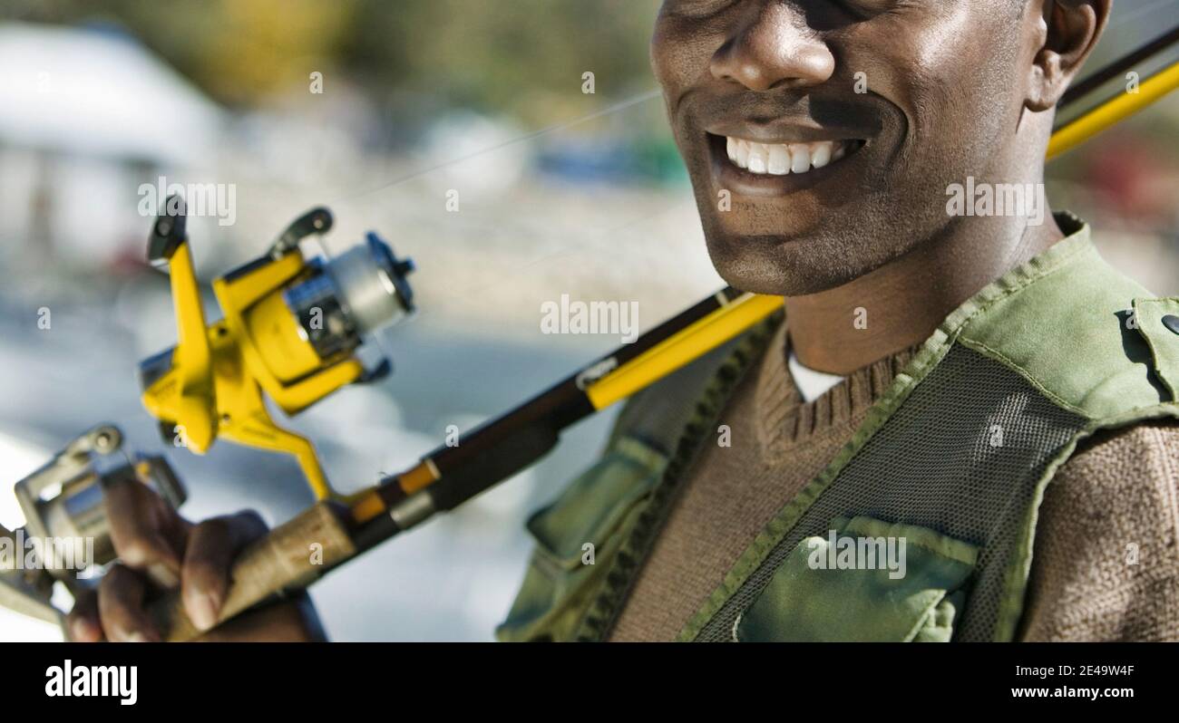 Fisherman with Rod and Reel Stock Photo - Alamy